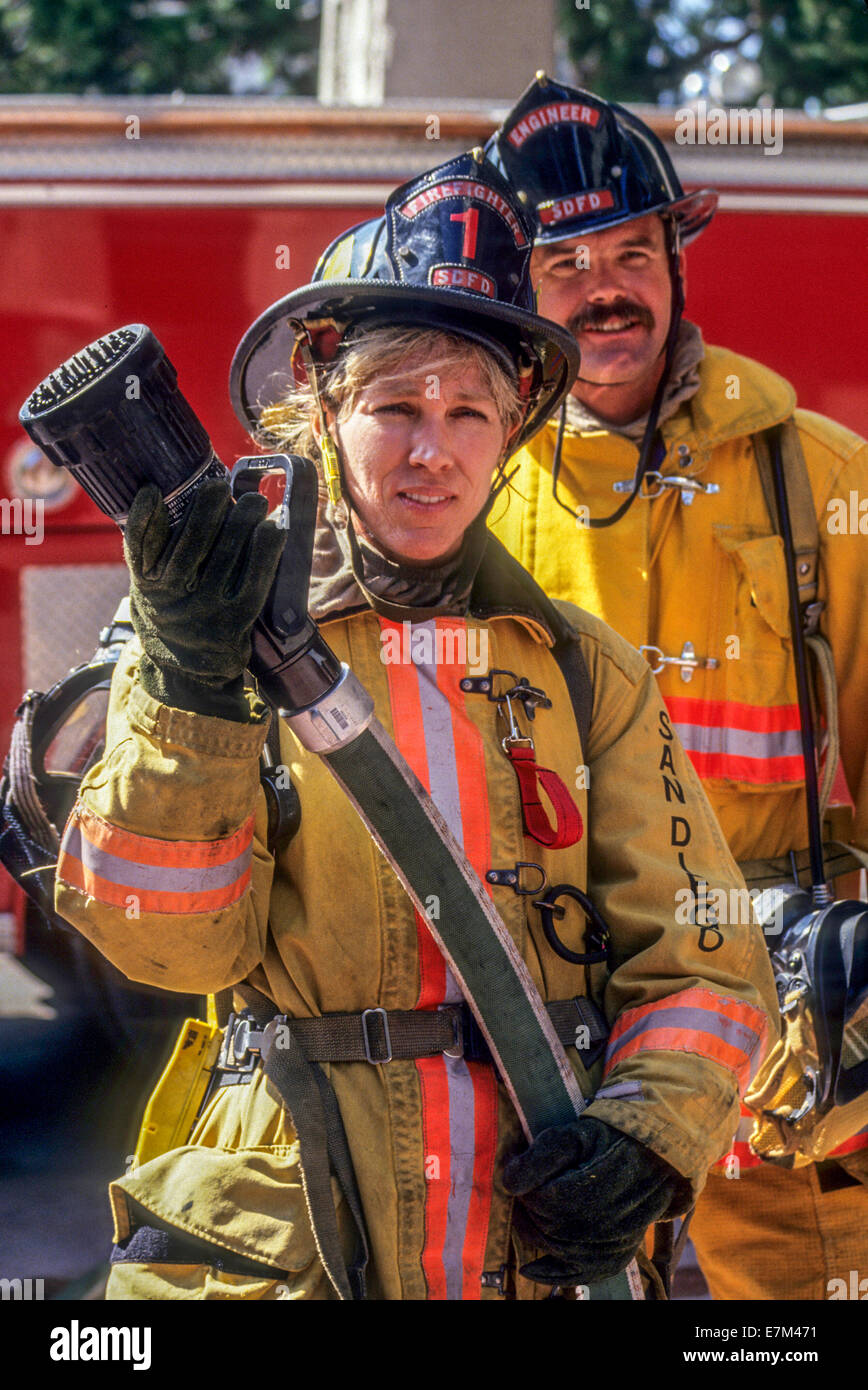 Wearing her fire helmet and fire coat, a San Diego, CA, woman ...