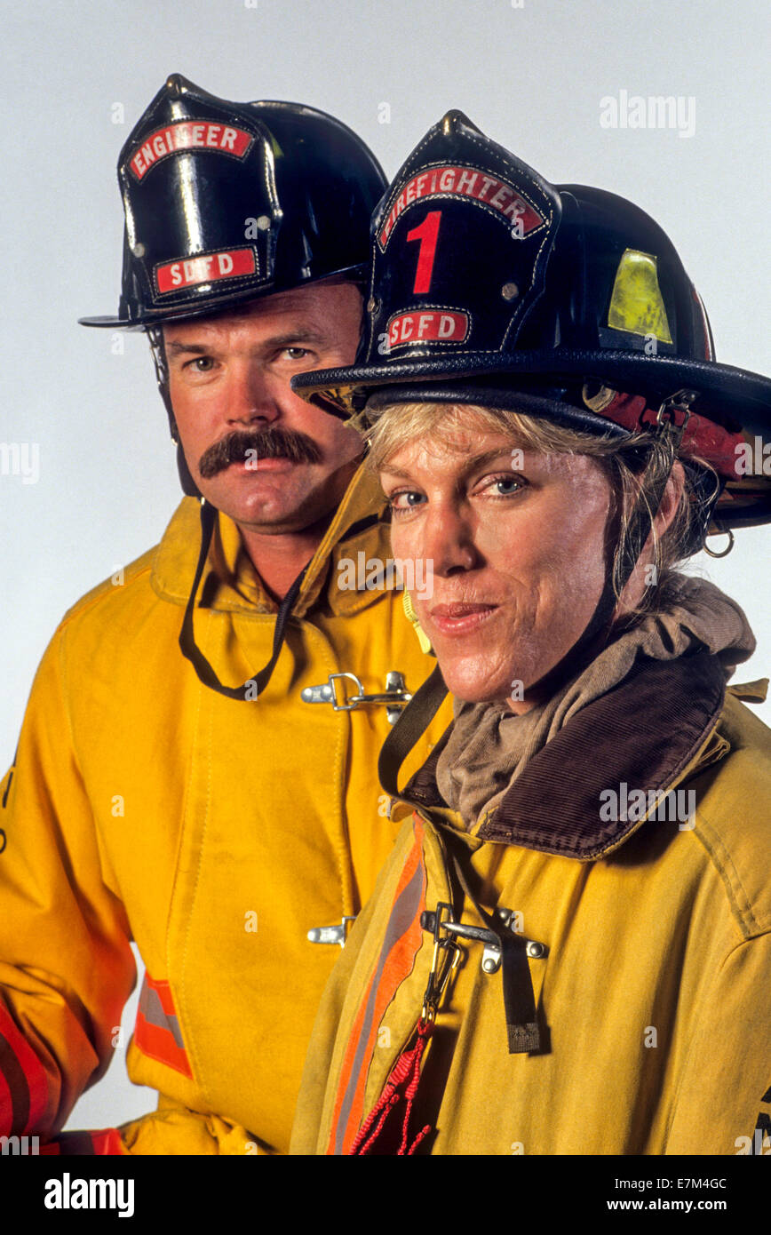 Male and female firefighters model protective coats and helmets in San ...