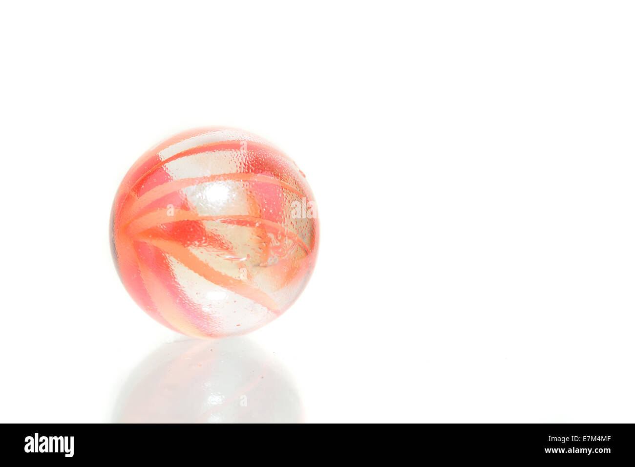 Single orange crystal marble isolated on white Stock Photo - Alamy