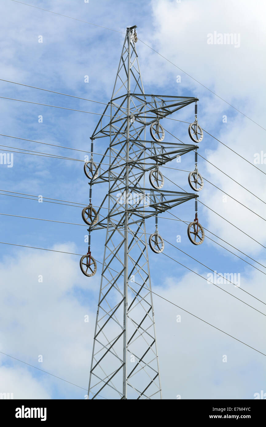 Electric pylon tower against a bright blue sky Stock Photo - Alamy