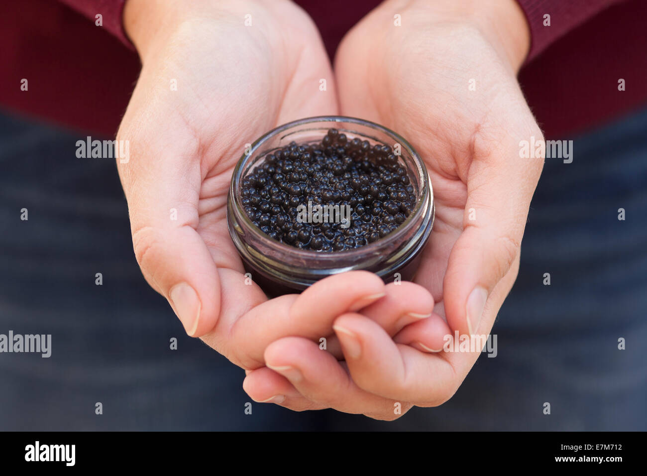 Caviar in a jar in woman's hand Stock Photo - Alamy