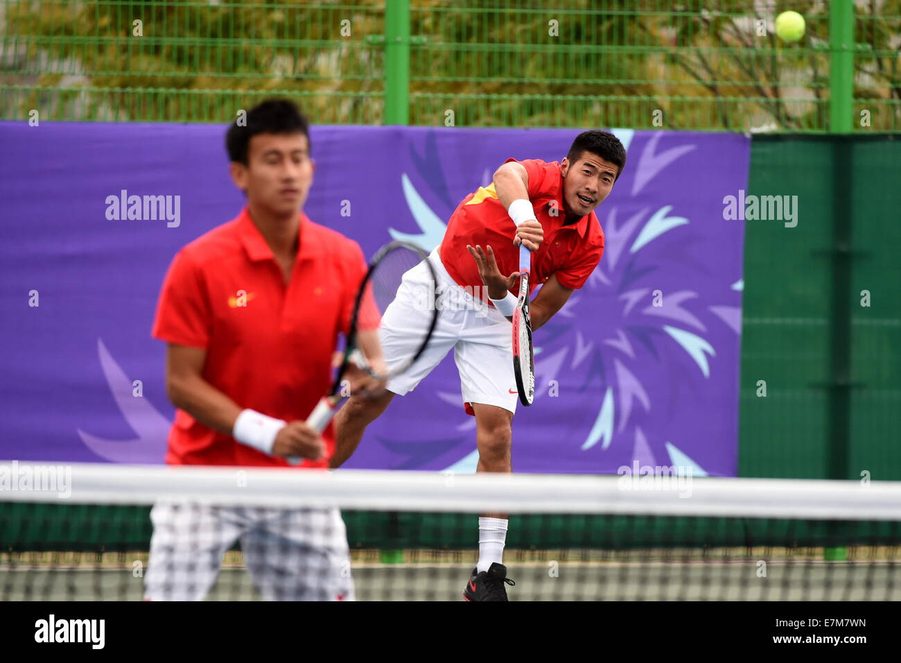 Incheon, South Korea. 21st Sep, 2014. Li Zhe (back) of China serves the ...