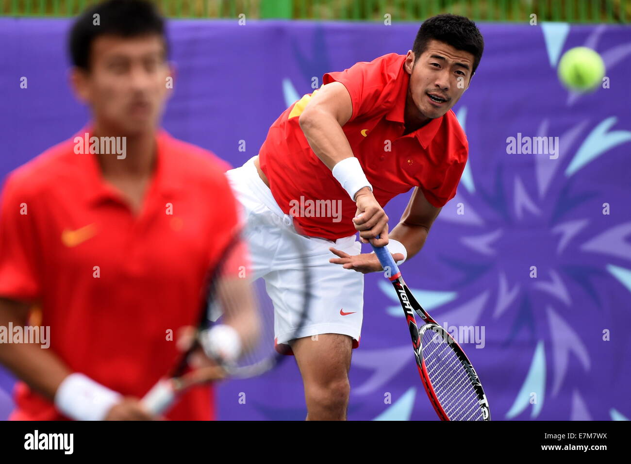 Incheon, South Korea. 21st Sep, 2014. Li Zhe (back) of China serves the ...