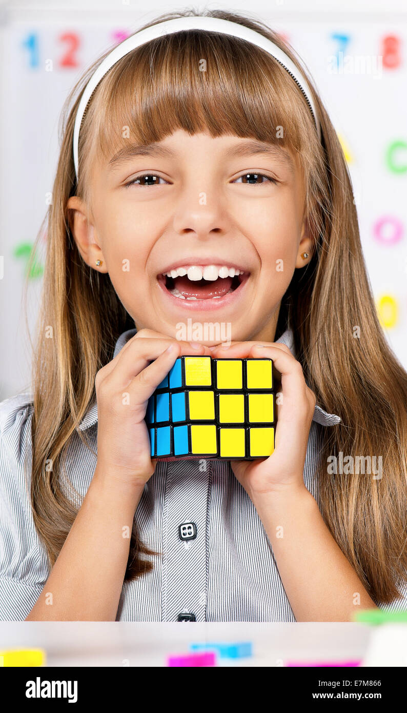 Girl with rubik cube Stock Photo - Alamy