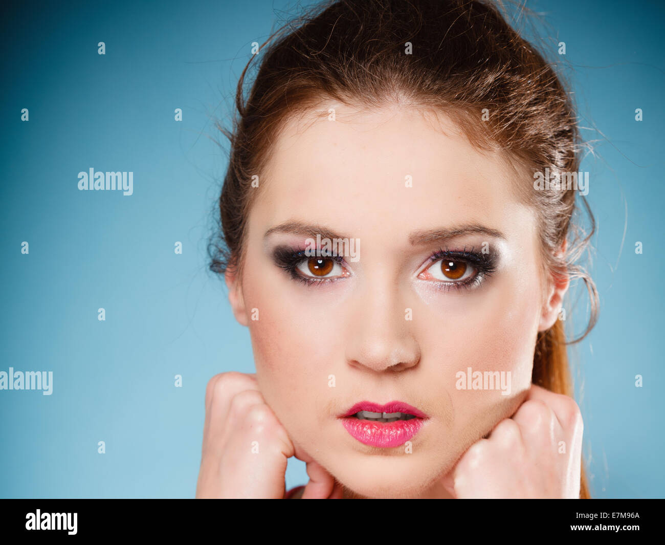 Young woman teen girl portrait on blue background Stock Photo - Alamy