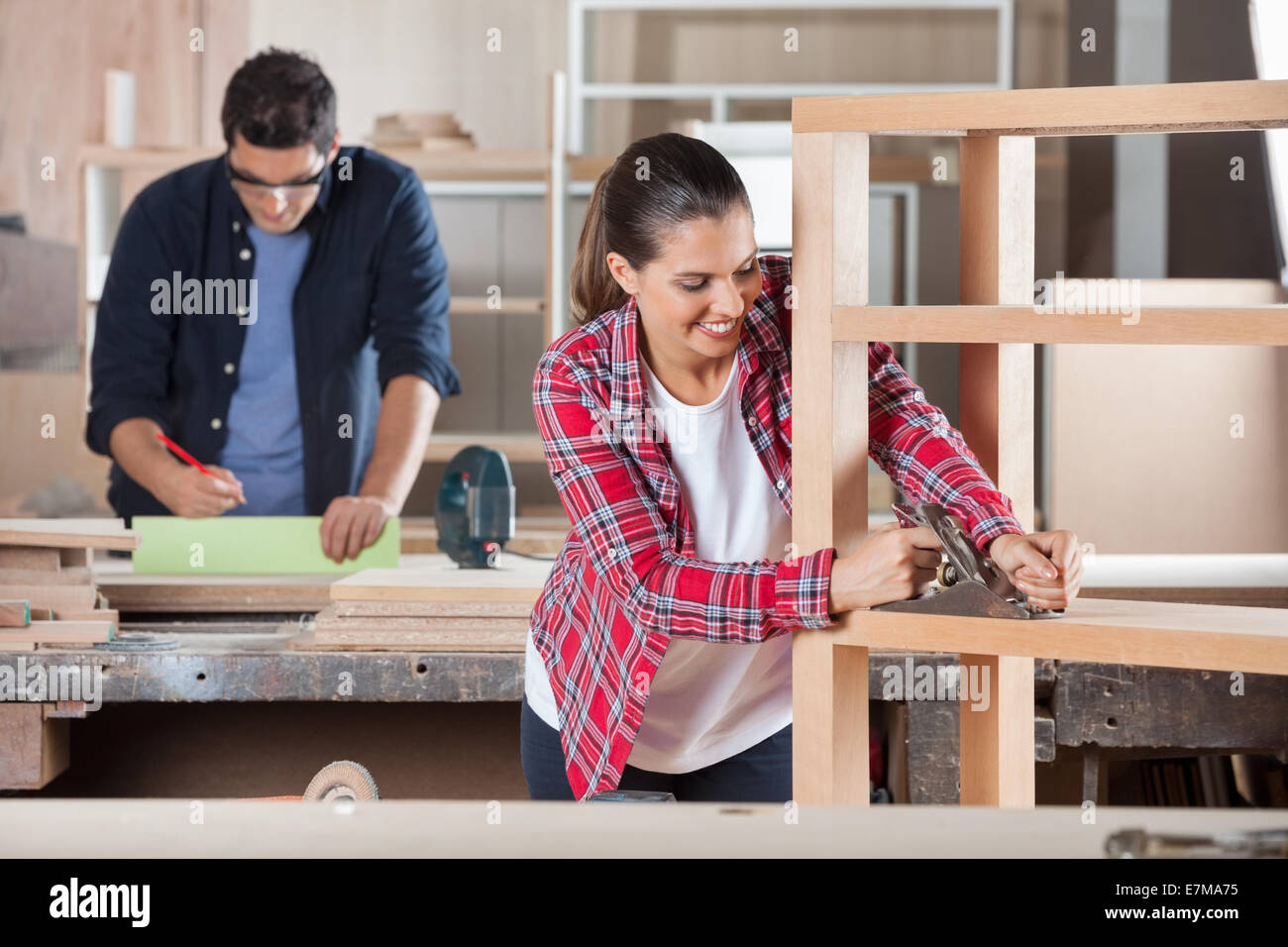 Carpenter Shaving Wood With Planer In Workshop Stock Photo - Alamy