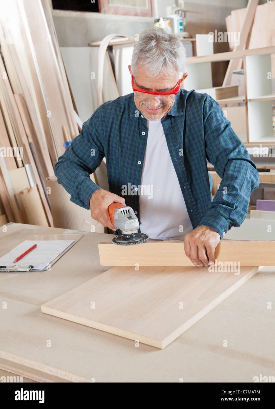 Carpenter Using Electric Sander At Table Stock Photo - Alamy