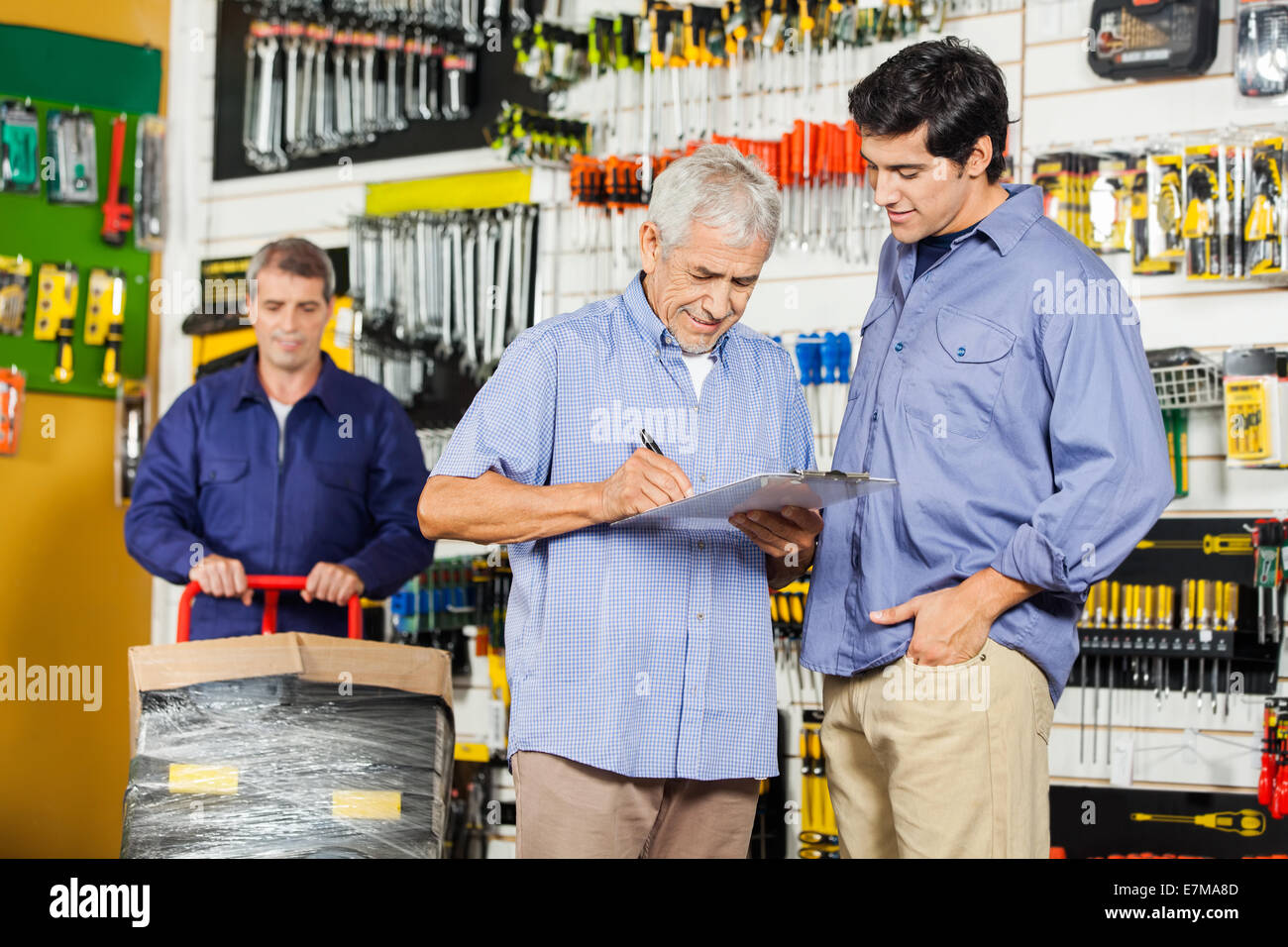Customers Writing On Checklist In Hardware Store Stock Photo - Alamy