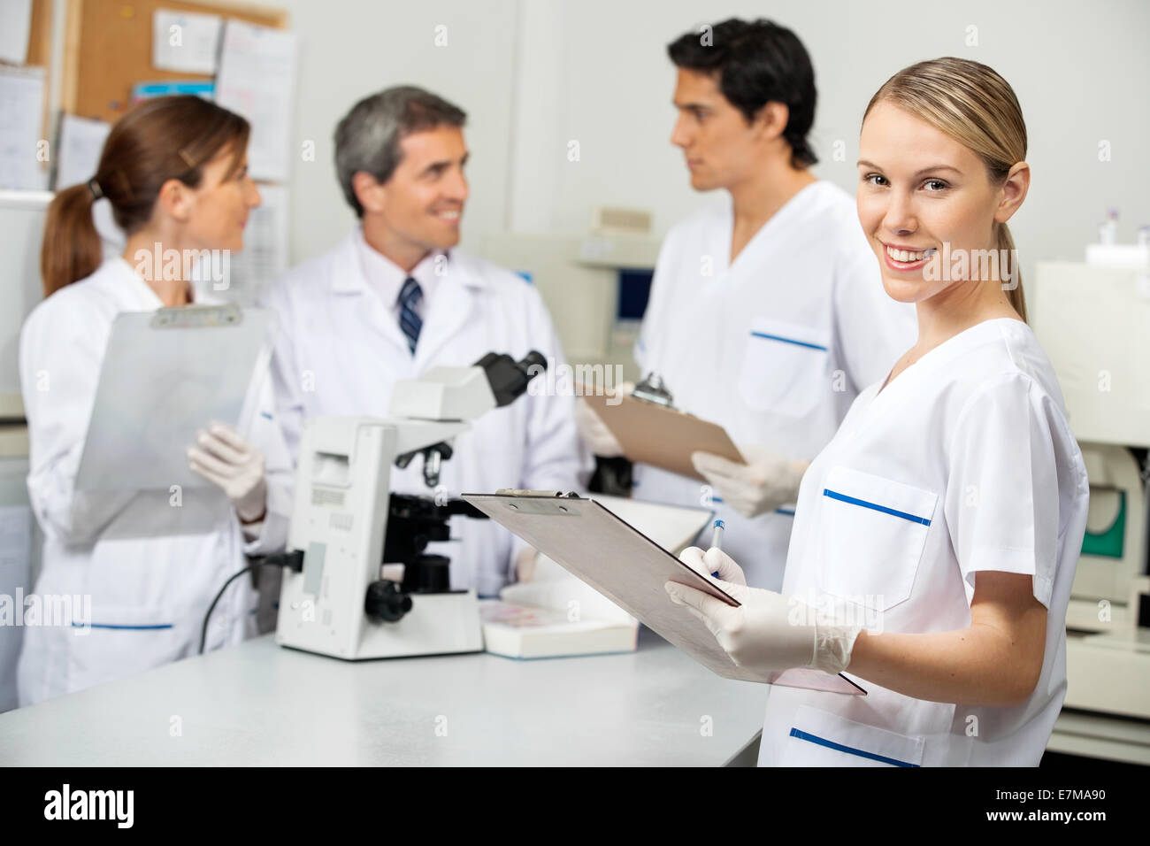 Woman laboratory assistant working on hi-res stock photography and ...