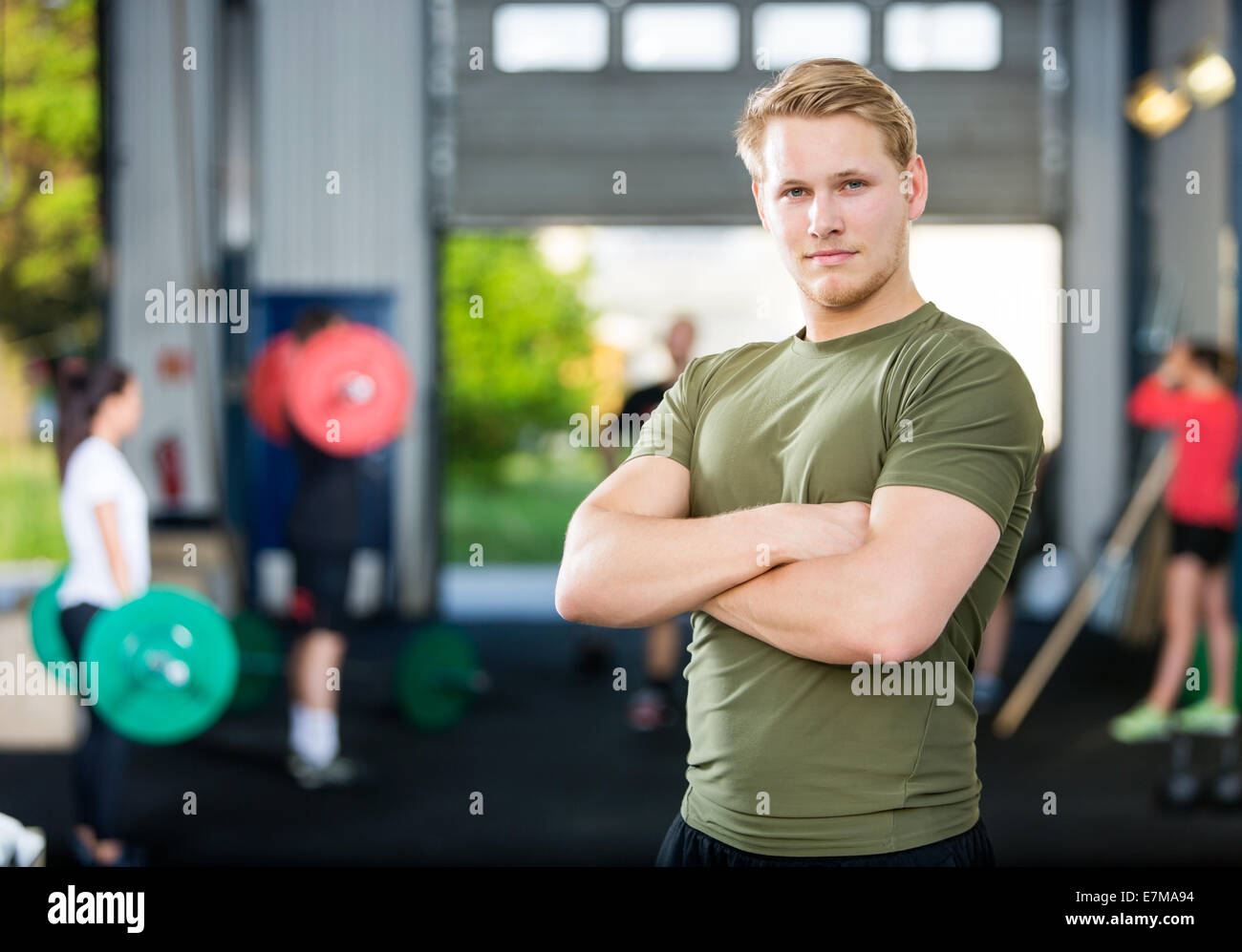 Male Athlete Standing Arms Crossed At Gym Stock Photo - Alamy
