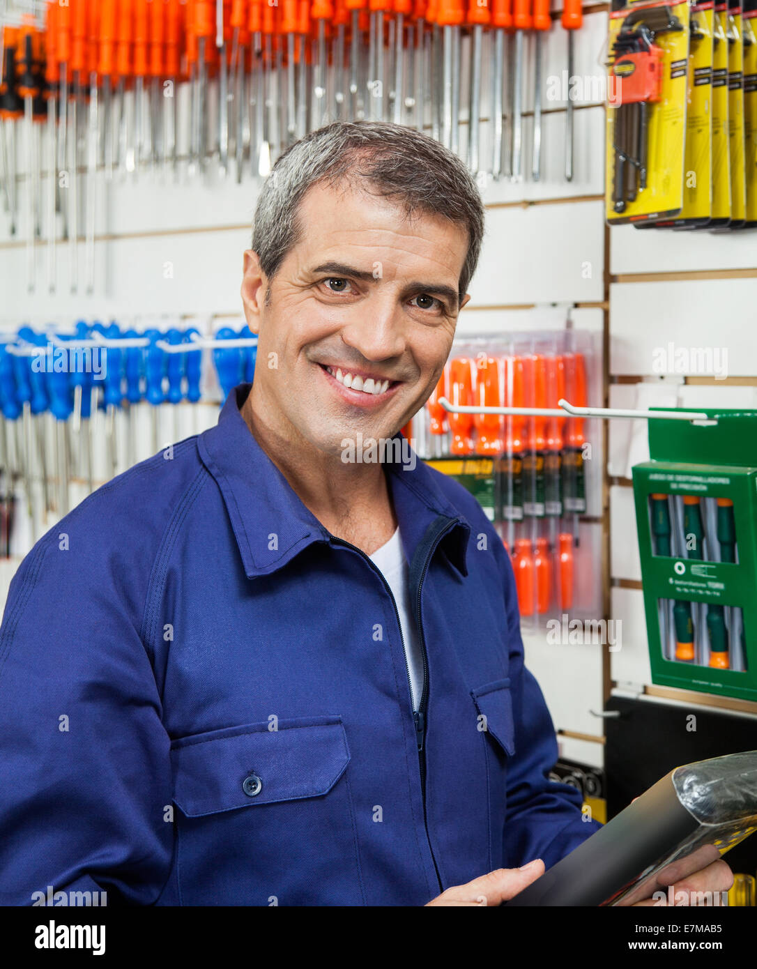 Confident Worker Holding Product In Hardware Store Stock Photo - Alamy