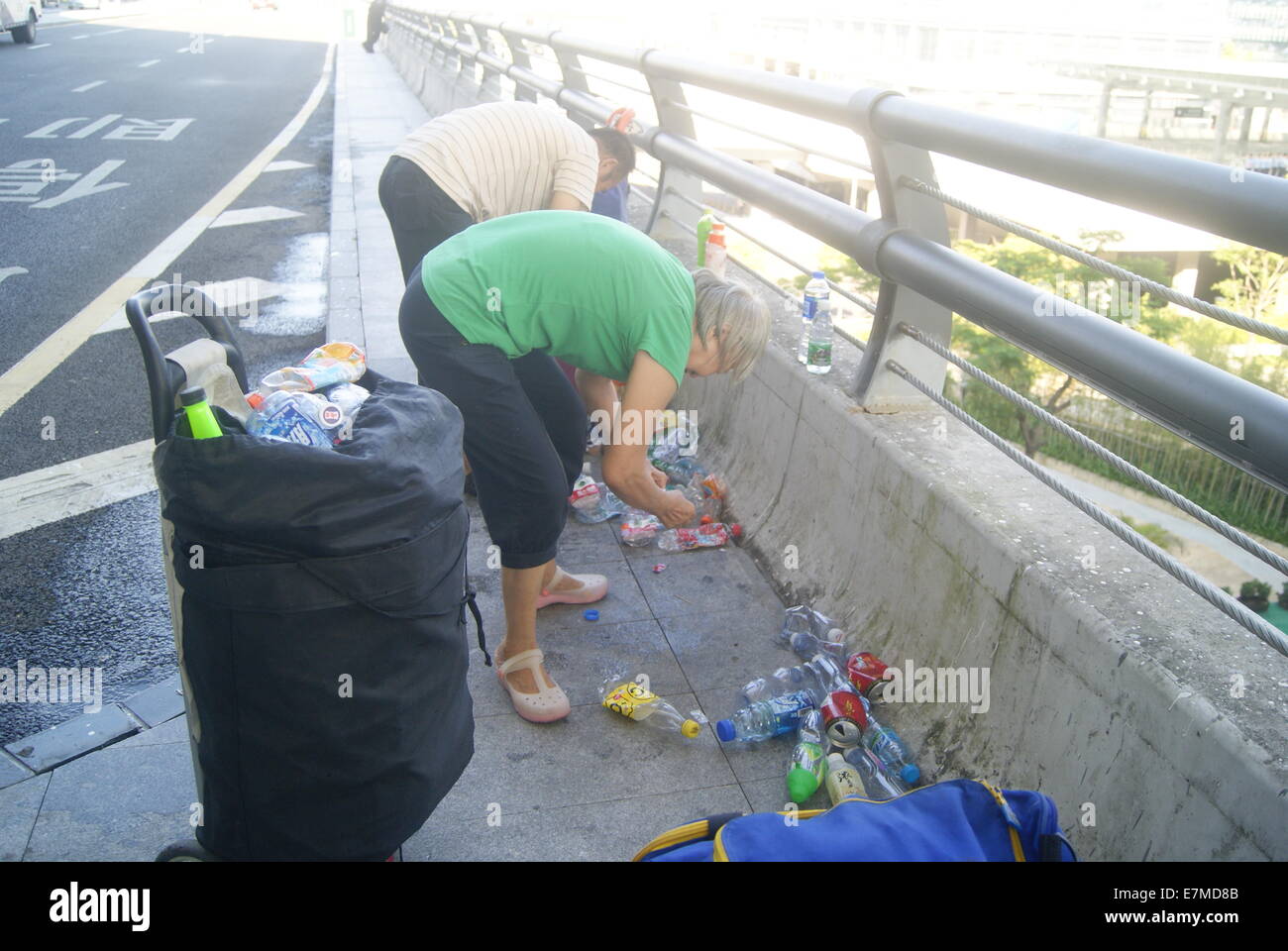 With grandparents collecting waste little girl, in China Stock Photo ...