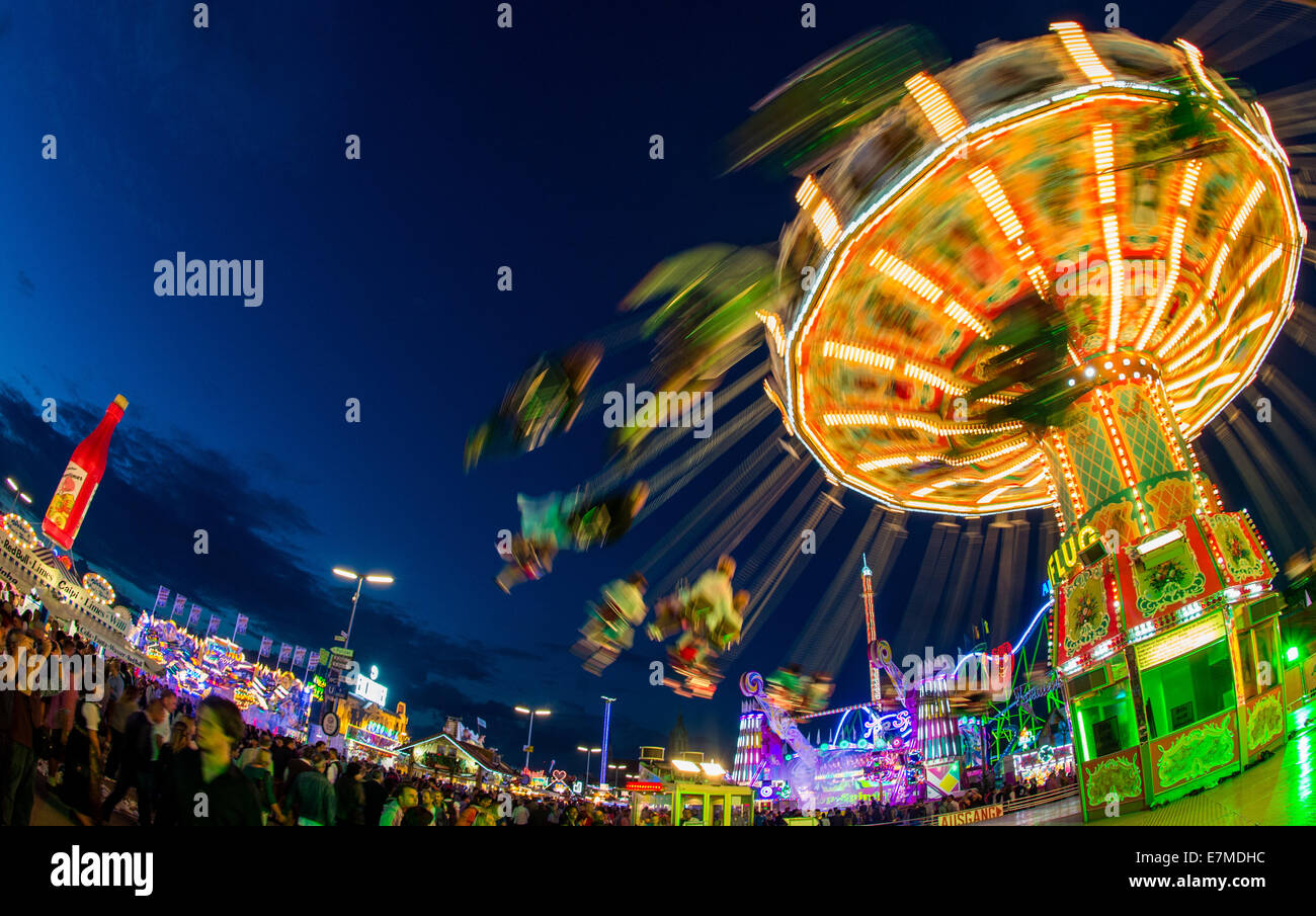 Munich, Germany. 20th Sep, 2014. Visitors sit on a merry-go-round at ...