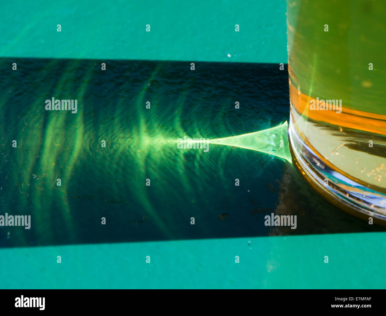Reflections of a full beer mug on a green metal table Stock Photo - Alamy