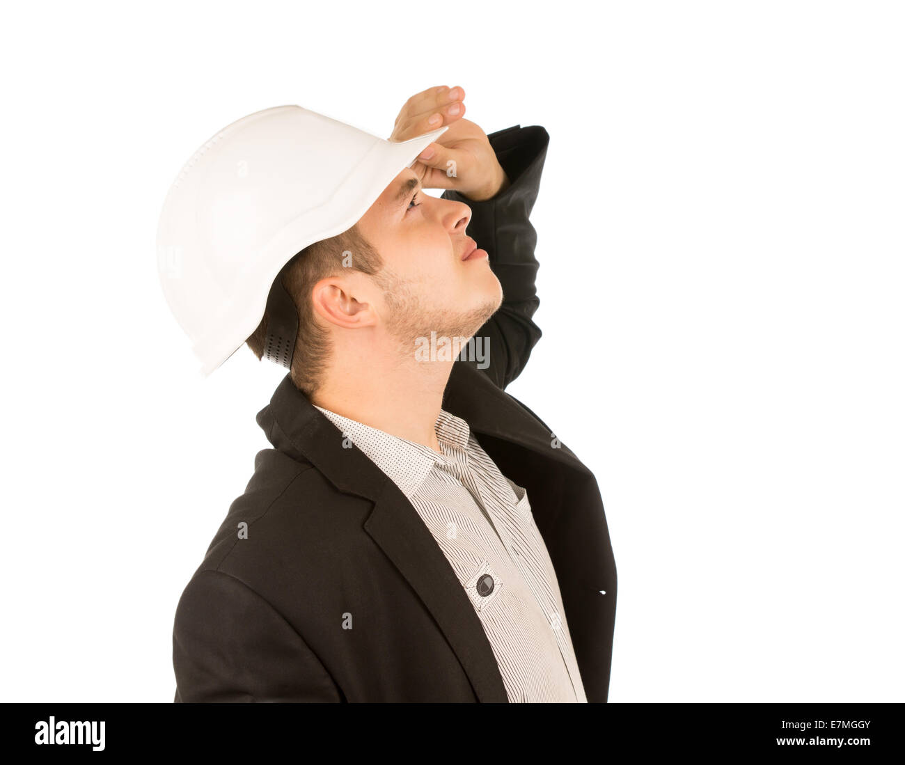 Close up Young White Engineer in White Helmet Looking Up. Isolated on ...