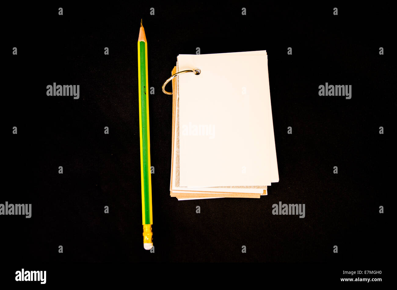 pencil and notebook on black background Stock Photo - Alamy