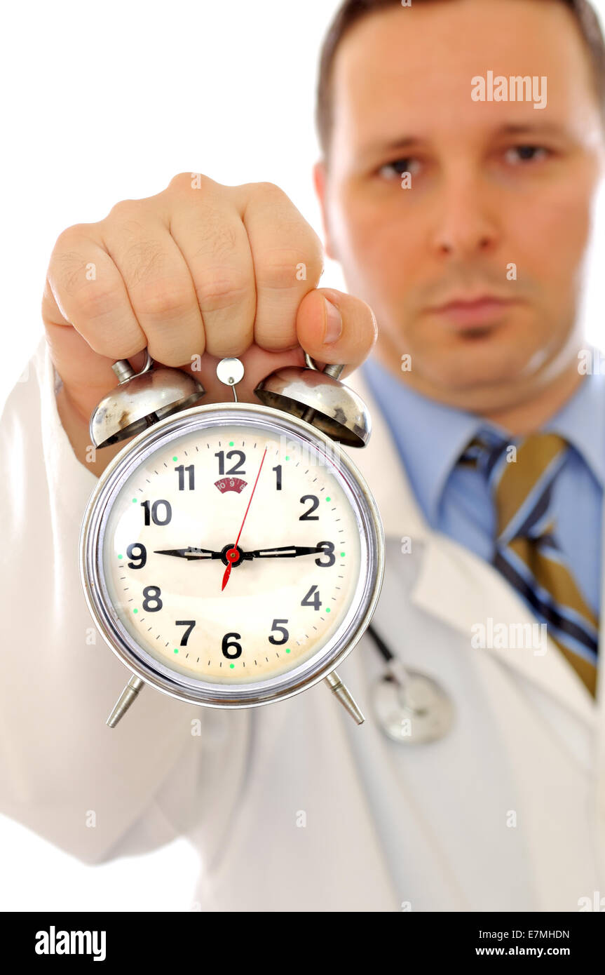 Doctor with alarm clock on the white background. Medical treatment time ...