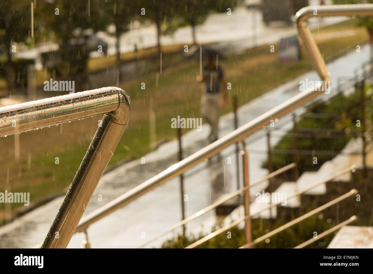 View from the top of a flight of steps with a metal railing of a man ...