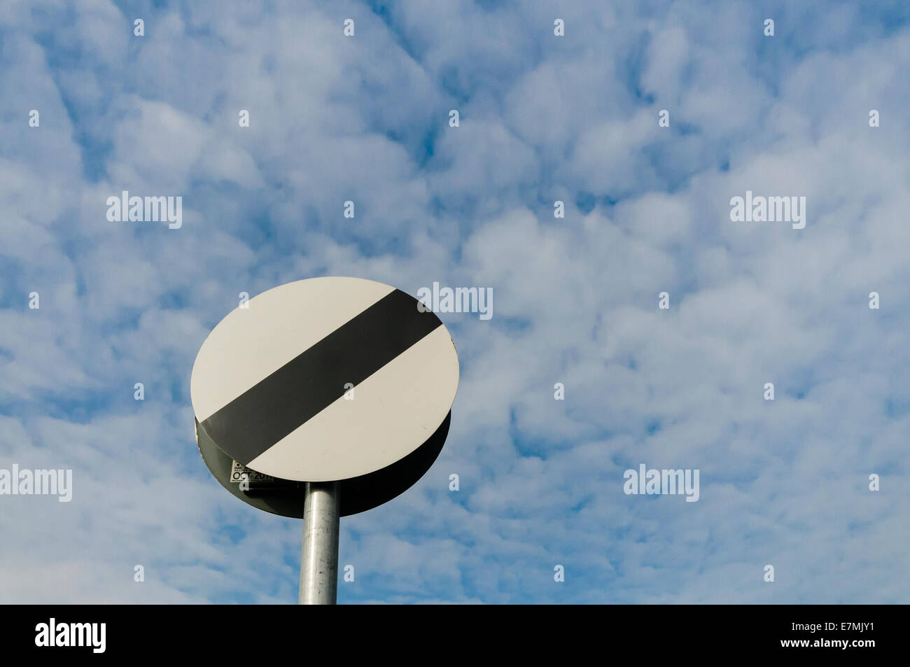National Speed Limit sign against a blue sky with clouds Stock Photo ...