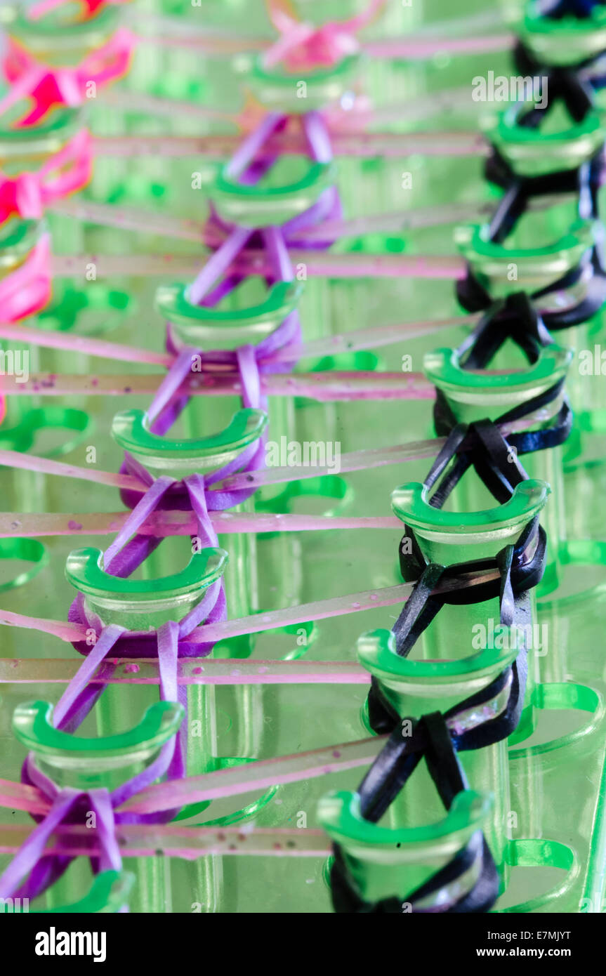 Making loom band friendship bracelets using a loom band frame Stock ...