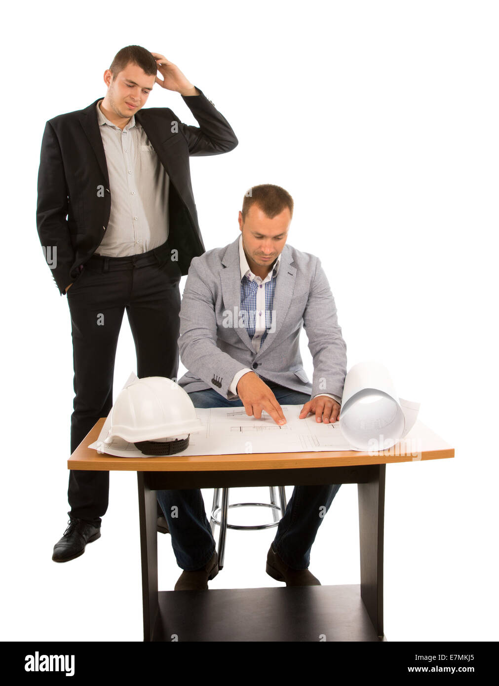 Two architects or builders working on a plan as a team trying to solve ...