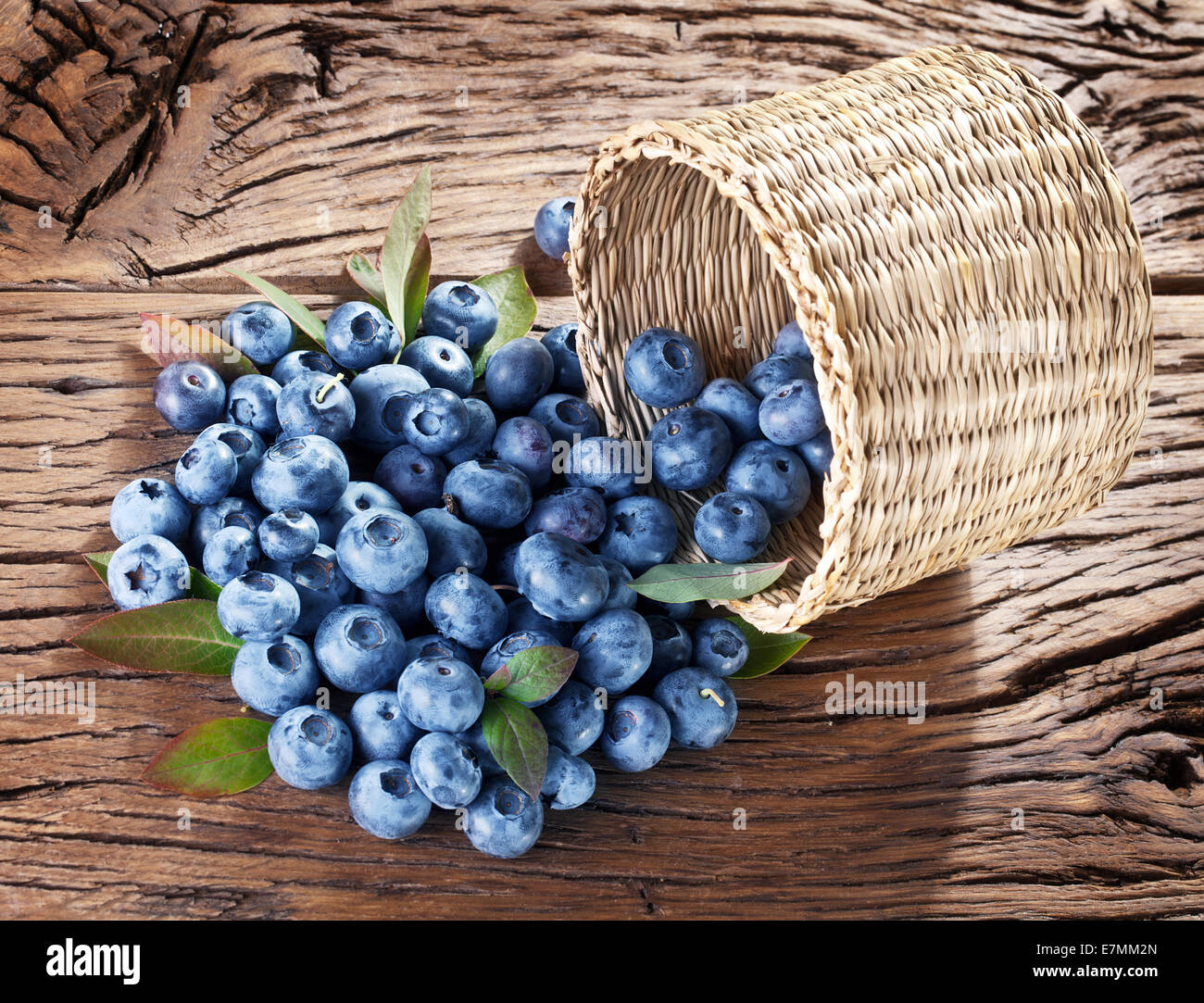 Blueberries over old wooden table Stock Photo - Alamy