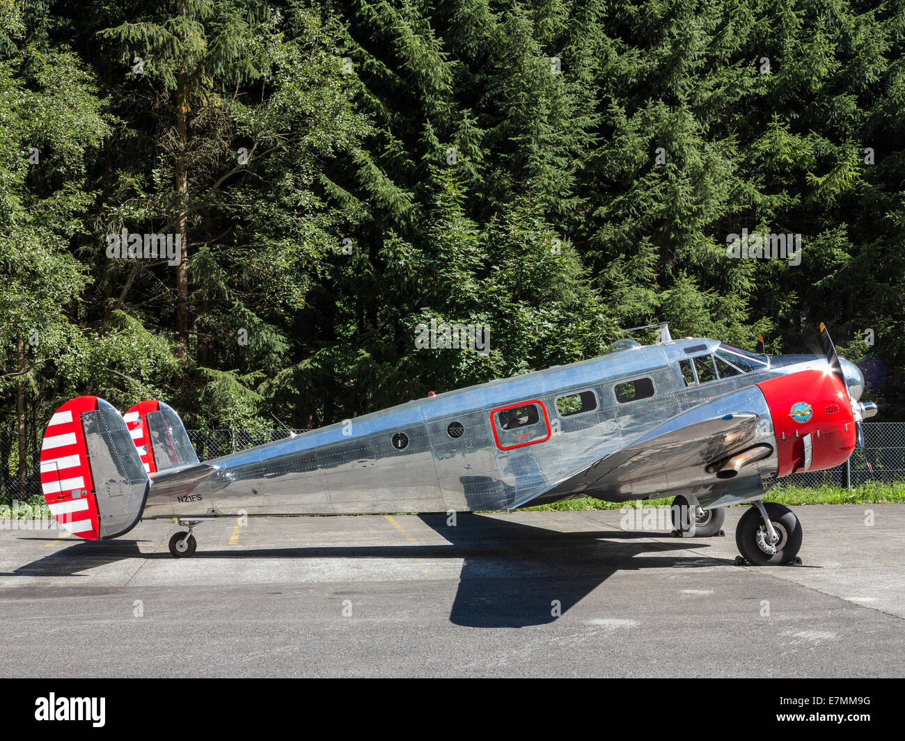 A veteran Beechcraft Twin aircraft (Beechcraft Model-18) parked against ...