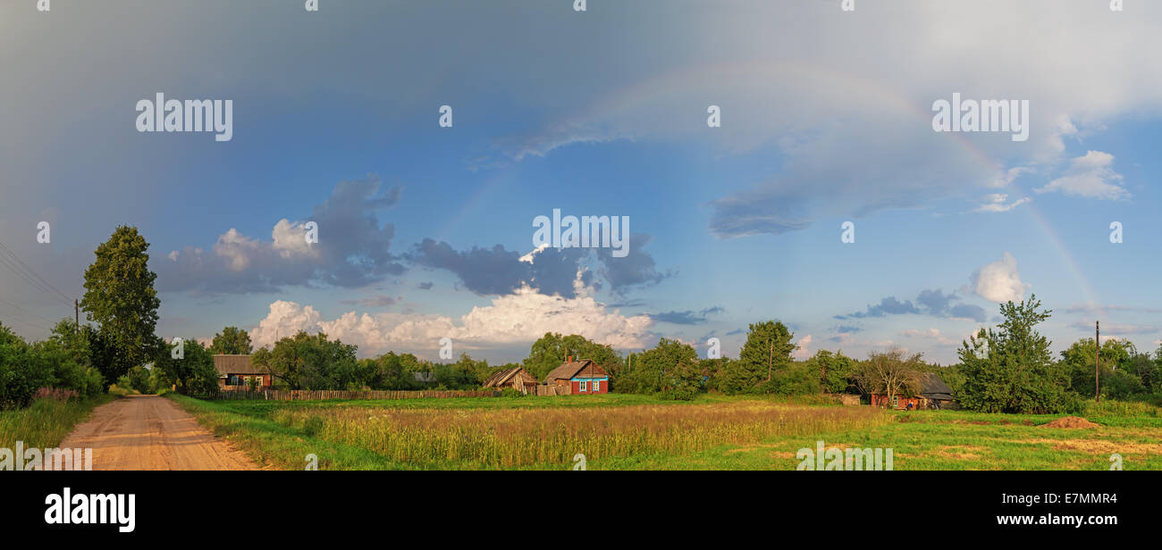 Rainbow gate over village Stock Photo - Alamy