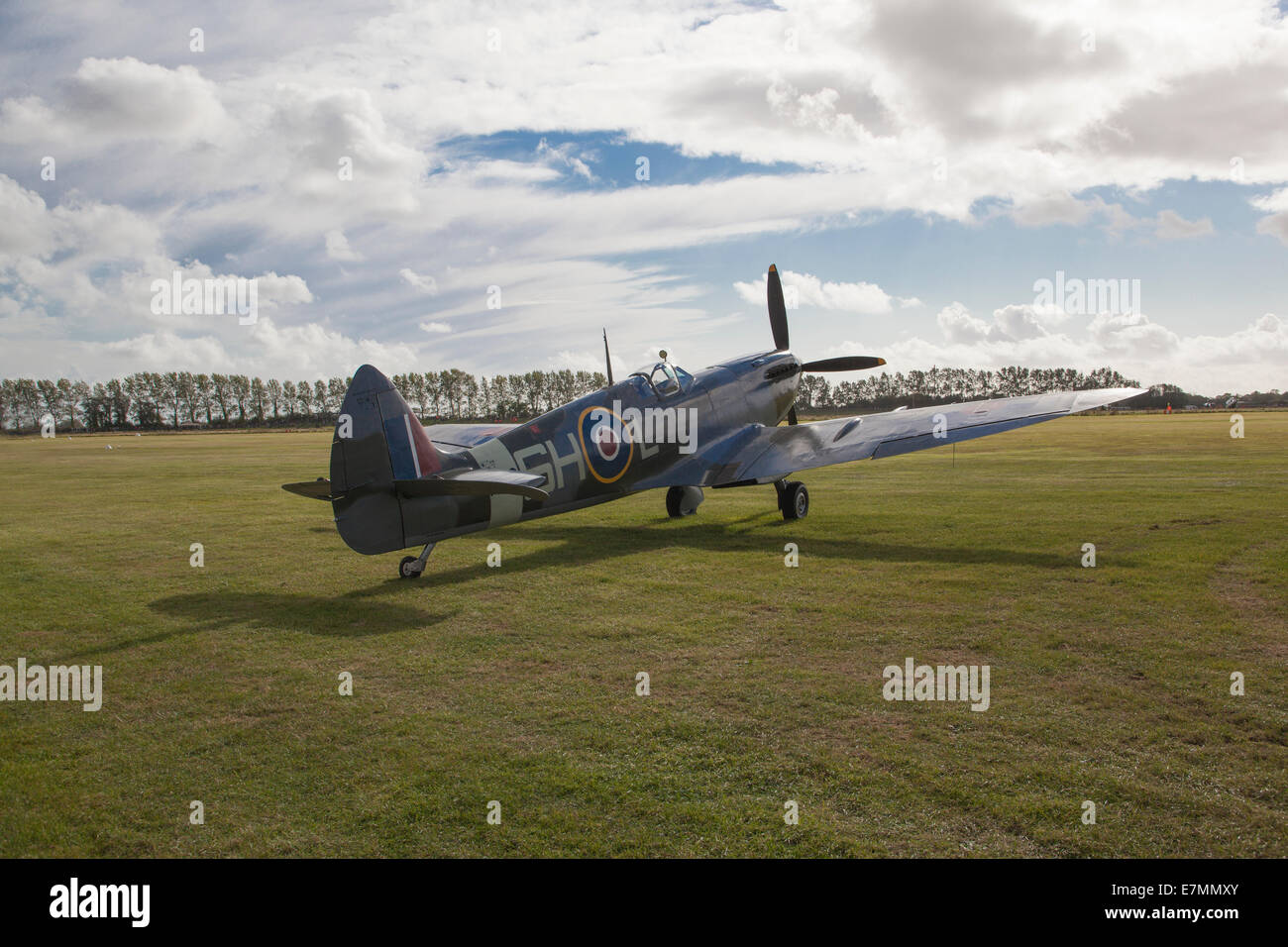 Spitfire and clouds Stock Photo - Alamy
