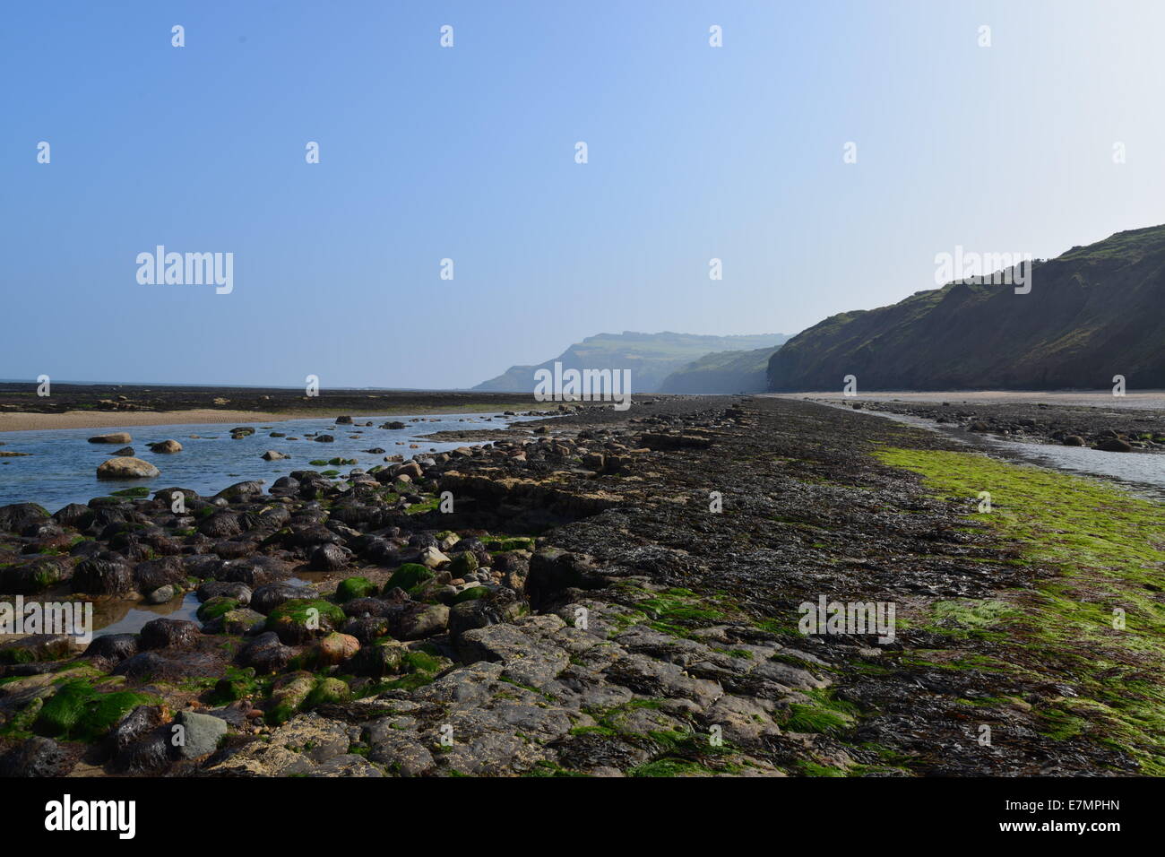 Rocks on the beach at Stoupe Beck clear blue sky Stock Photo - Alamy