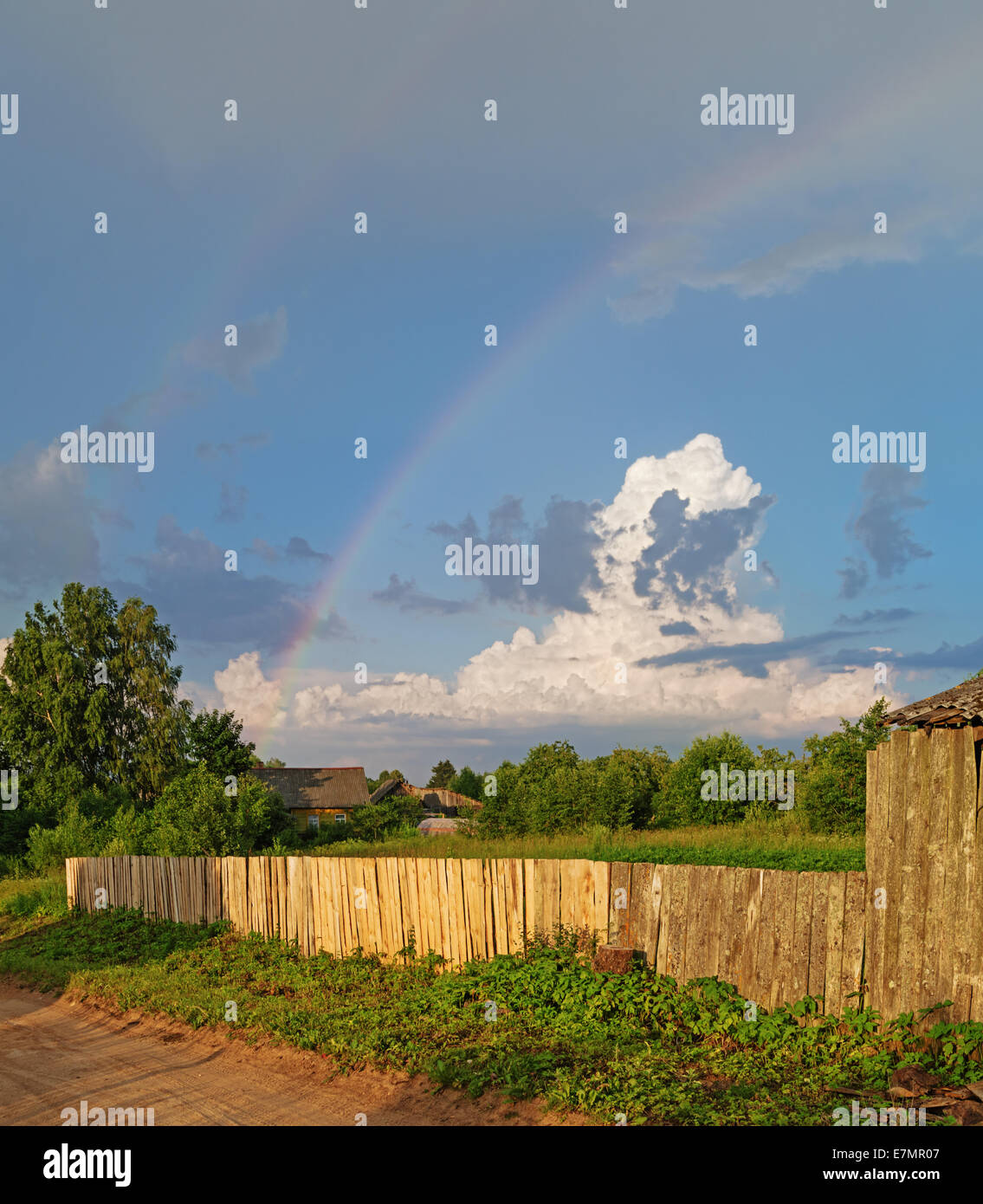 Rainbow over village Stock Photo - Alamy