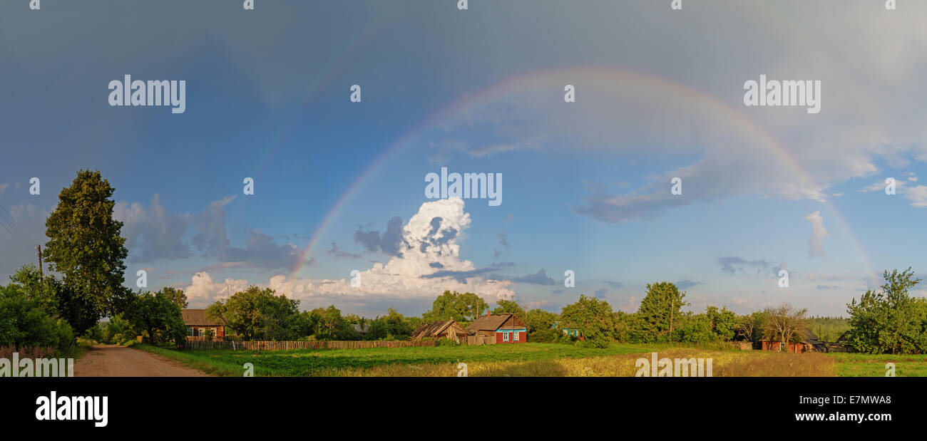 Rainbow gate over village Stock Photo - Alamy