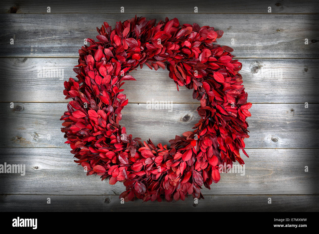 Top view of autumn wreath consisting of real tree leaves on rustic wood ...