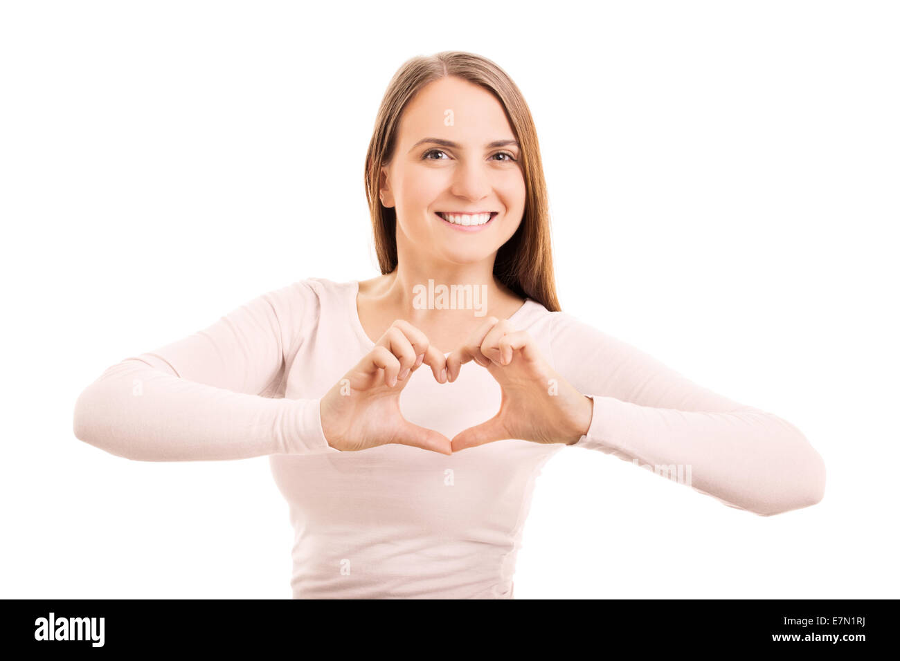 Beauty portrait of a smiling young girl making a heart shaped hand ...