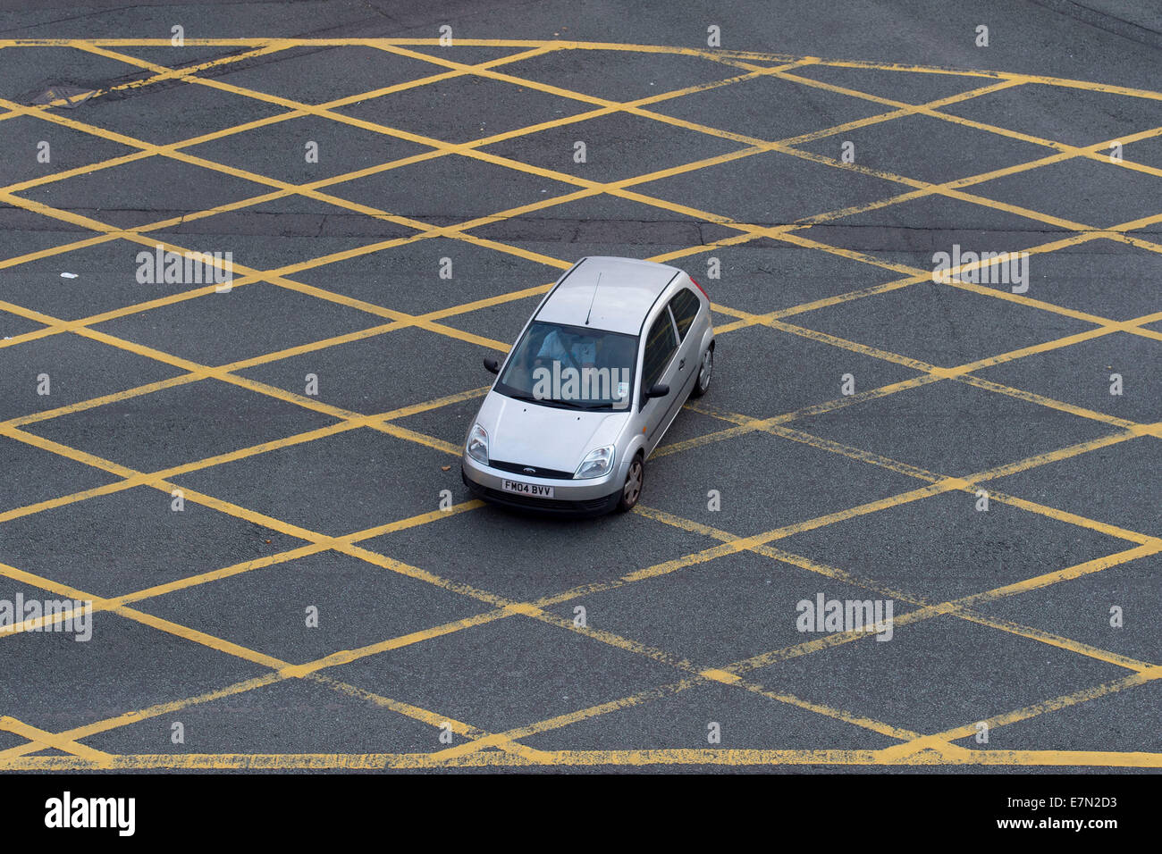 A silver car drives through a yellow box junction in Cardiff, South ...