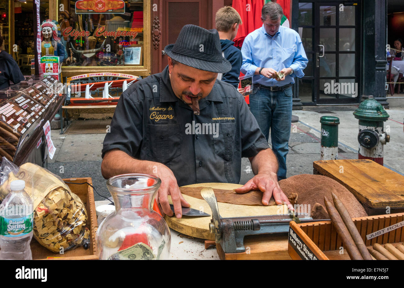 Italian man making cigars by hand on Mulberry Street in Little Italy in ...