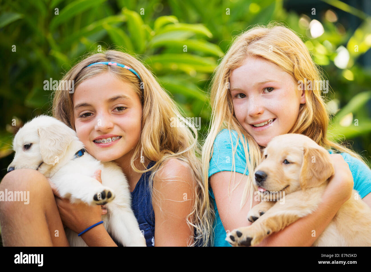 Adorable Cute Young Girls with Puppies Stock Photo - Alamy