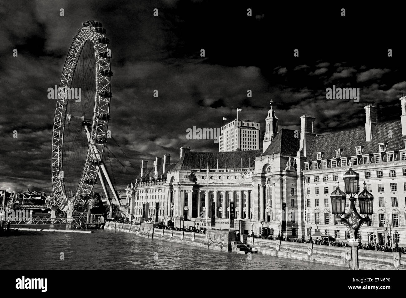 View of County Hall along the River Thames showing the London Eye ...