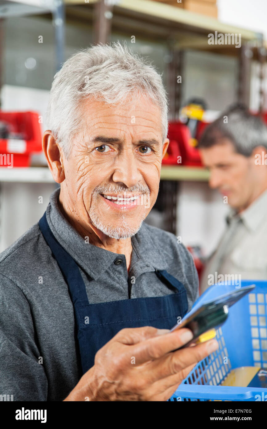 Confident Senior Salesman Holding Tool In Store Stock Photo - Alamy