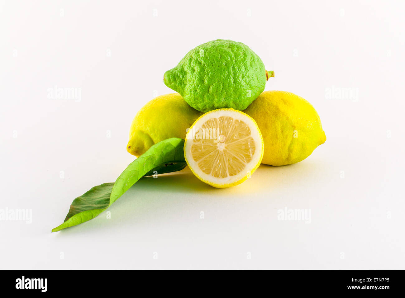 Fresh lemons yellow and green on white background Stock Photo - Alamy