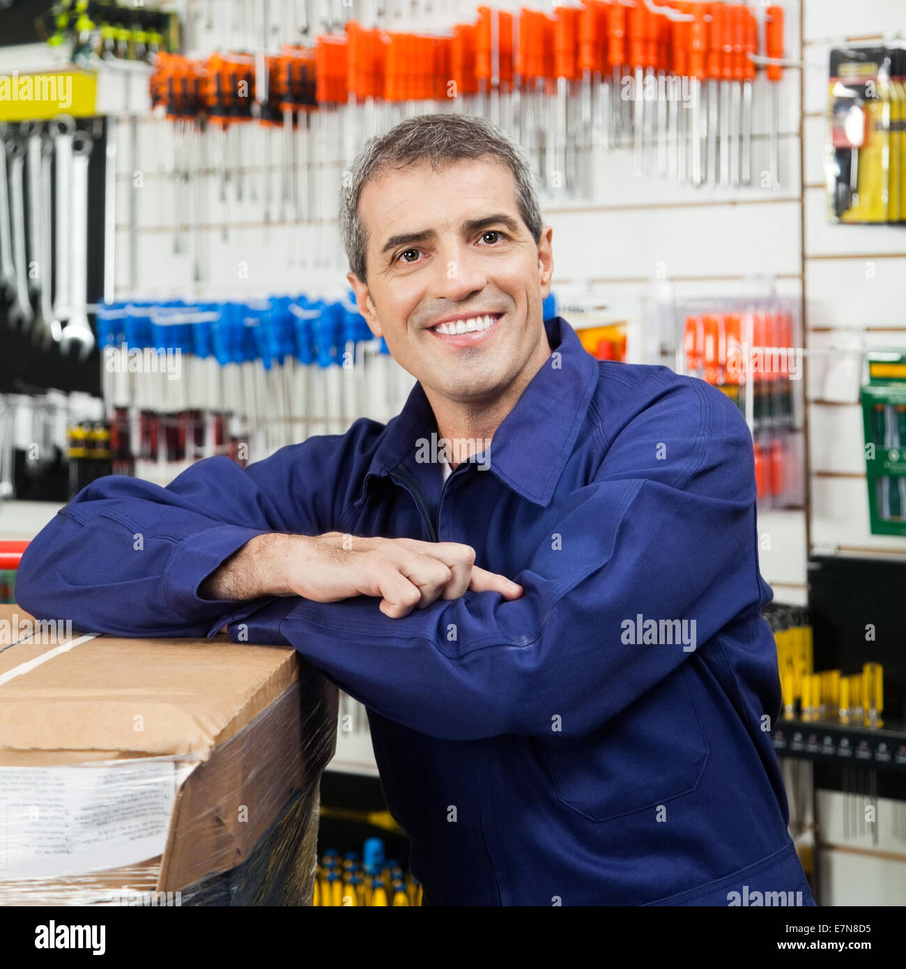 Worker Leaning On Tool Package In Hardware Shop Stock Photo - Alamy