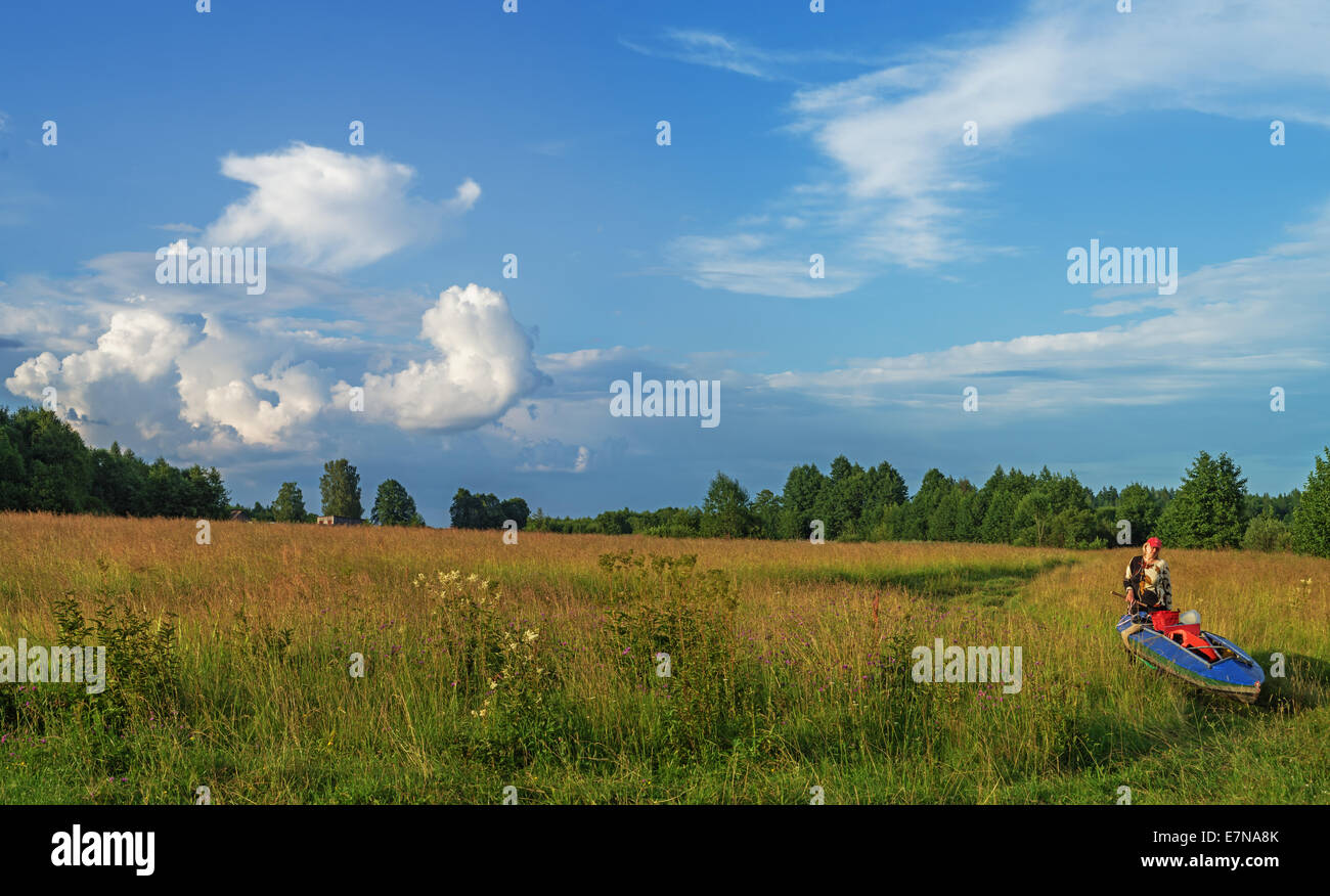 Woman, canoe with wheels on rural road Stock Photo - Alamy