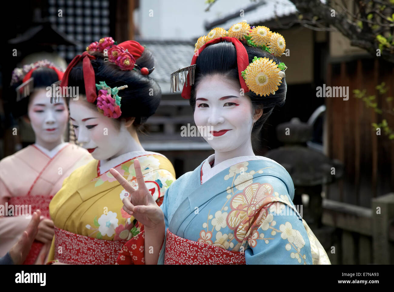 Japanese woman, geisha posing for a picture and smiling at camera, Gion ...