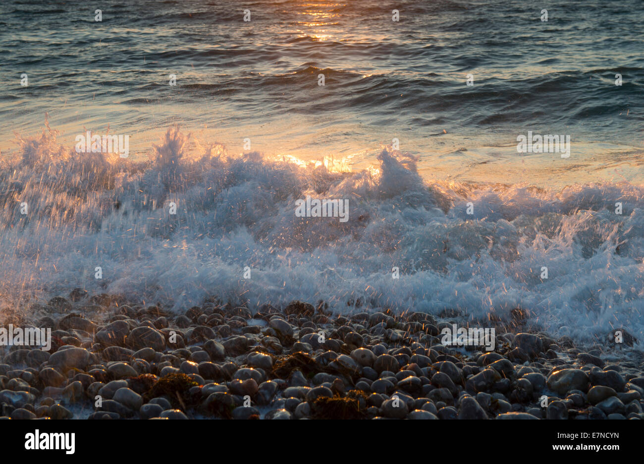 Sunset on the beach at Etratat on the coast of Normandy in Northern ...
