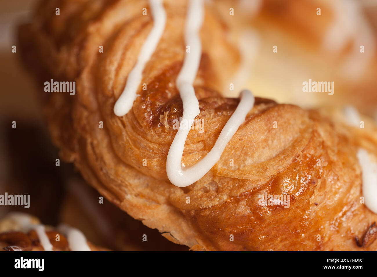 appetizing flaky puff pastry pastry with coiled strand of icing sugar ...