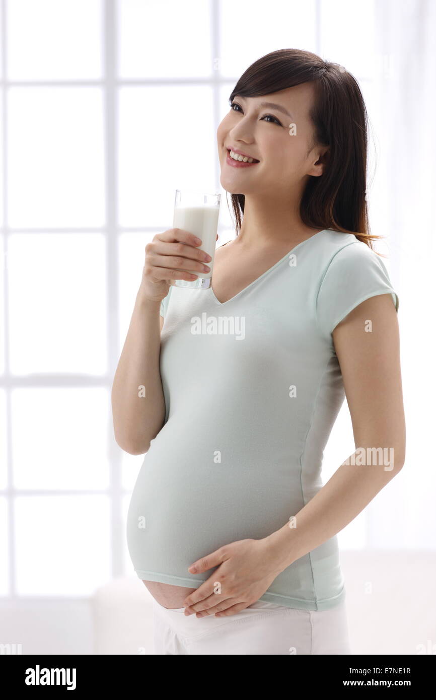 Pregnant woman drinking milk Stock Photo - Alamy