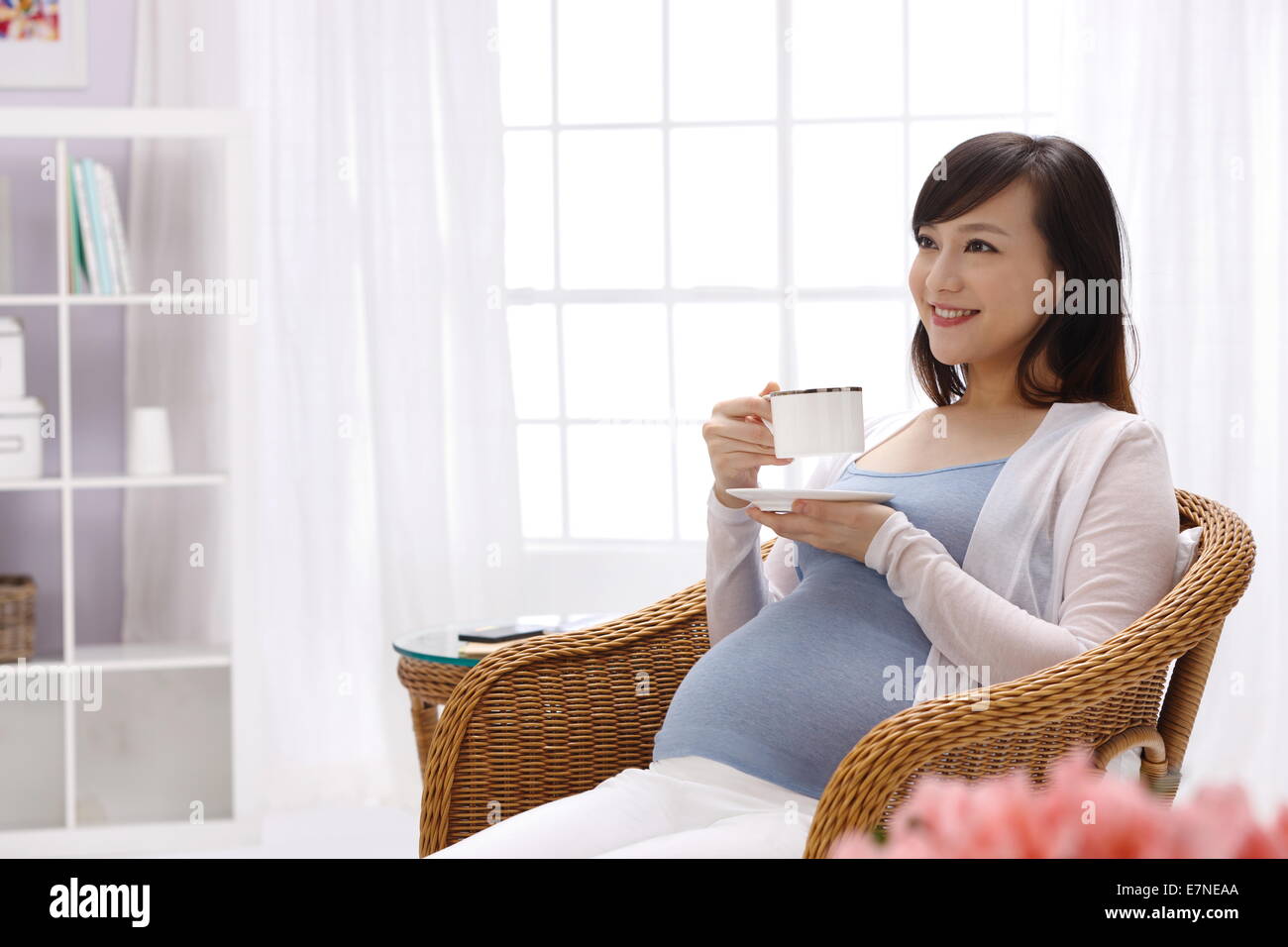 Pregnant woman drinking water Stock Photo - Alamy