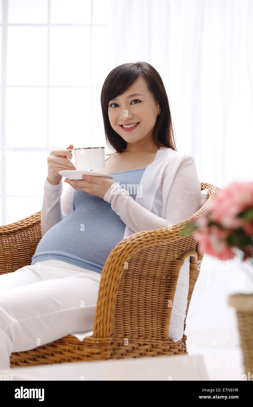 Pregnant woman drinking water Stock Photo - Alamy