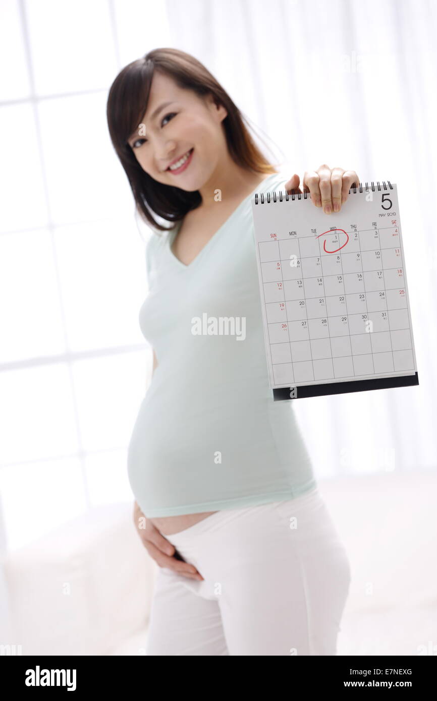 Pregnant woman with calendar Stock Photo - Alamy