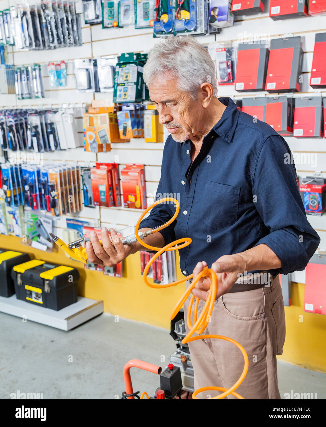 Man Analyzing Air Compressor Hose In Shop Stock Photo - Alamy